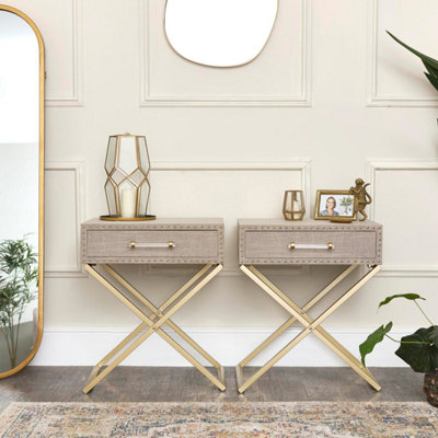 Melody Maison Pair of Beige Linen Gold Cross Leg Bedside Side Table