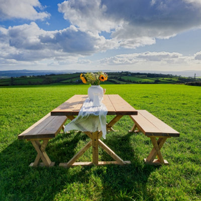 OUTDOOR TABLE WITH TIMBER CROSS LEGS AND 2 BENCHES