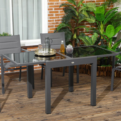 Extendable outdoor dining table with umbrella hole store
