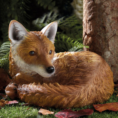 Realistic curled-up fox ornament with hand-painted details. Weather ...