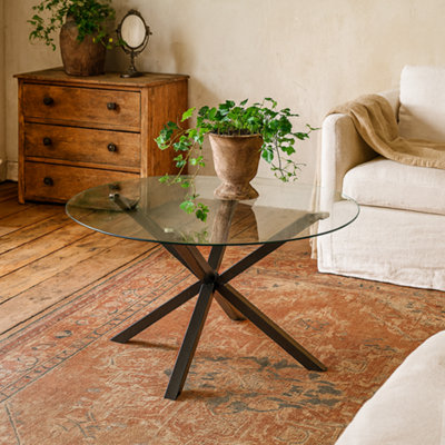 Saignon 1200mm Round Glass Dining Table with Black Cross-Leg Metal Base
