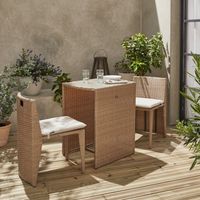 sweeek. Ready assembled 2 seater space saving rattan table set Doppio Natural rattan Beige cushions