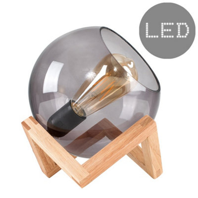 ValueLights Cruz Smoked Glass Globe Bedside Table Lamp on a Wooden ...